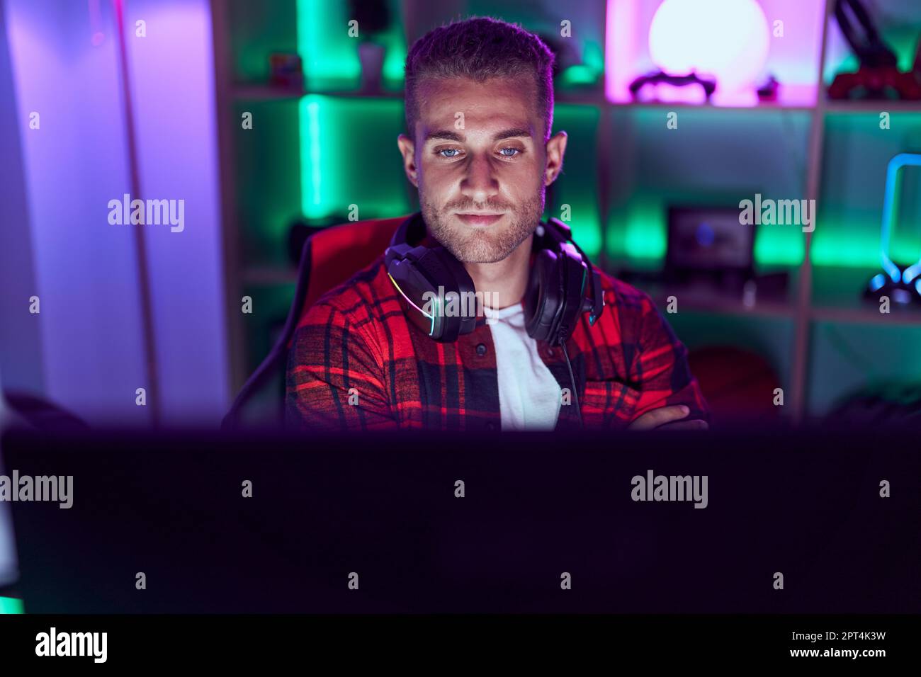 Young caucasian man streamer playing video game using computer at ...