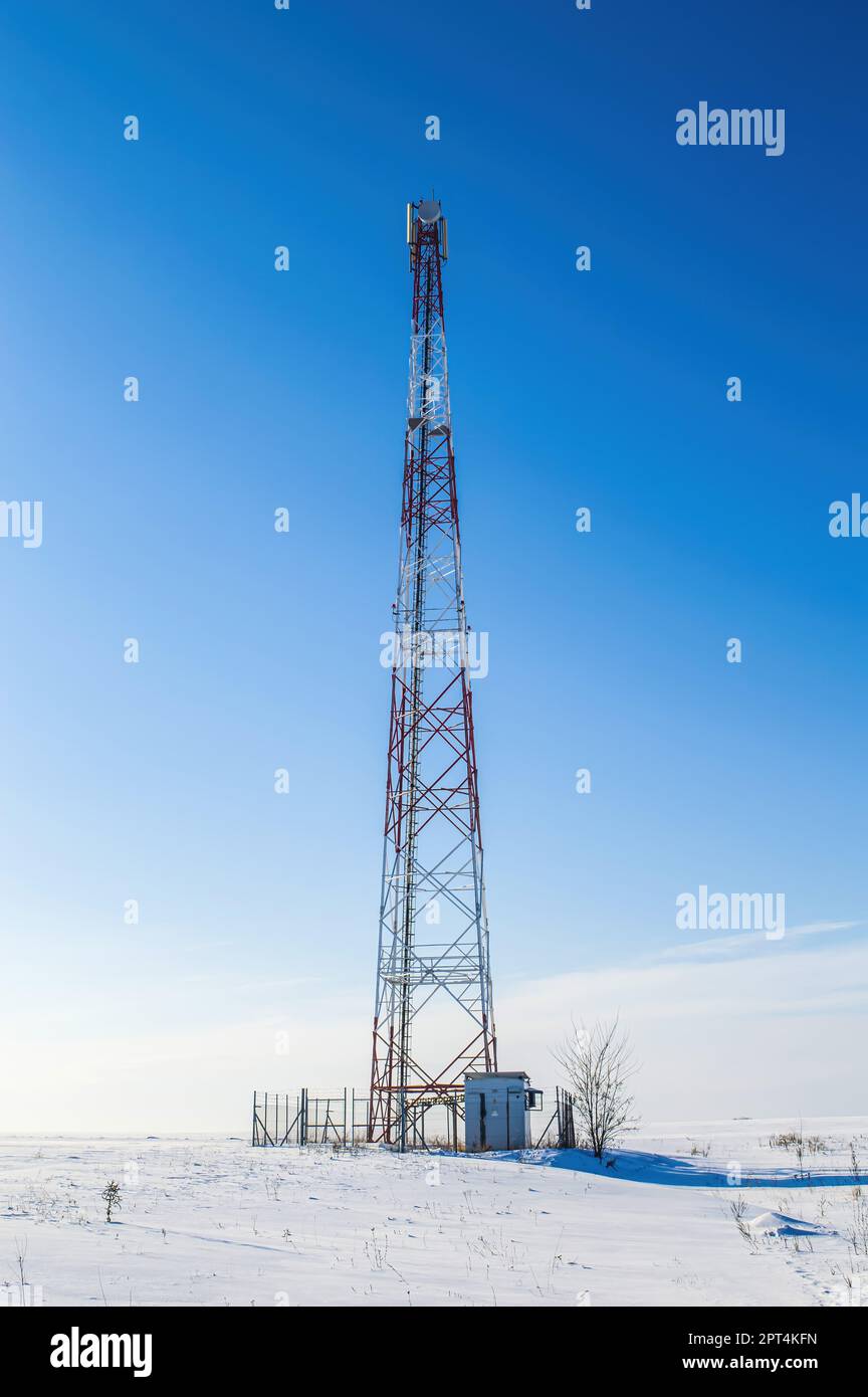 Mobile tower in a snow-covered white field against a blue sky. Data ...