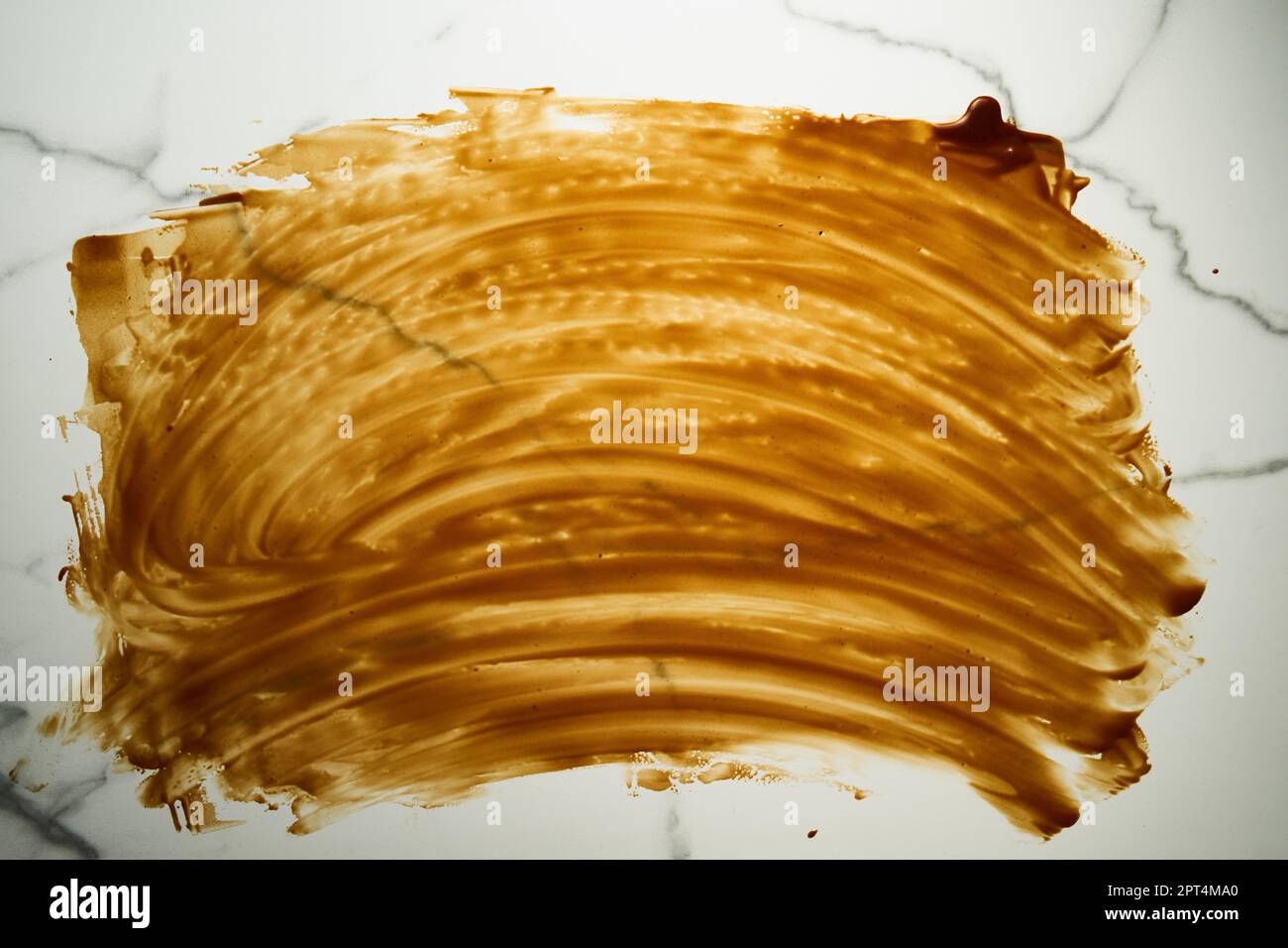 Salted Caramel sauce smeared on the tabletop. A tabletop stained with ...