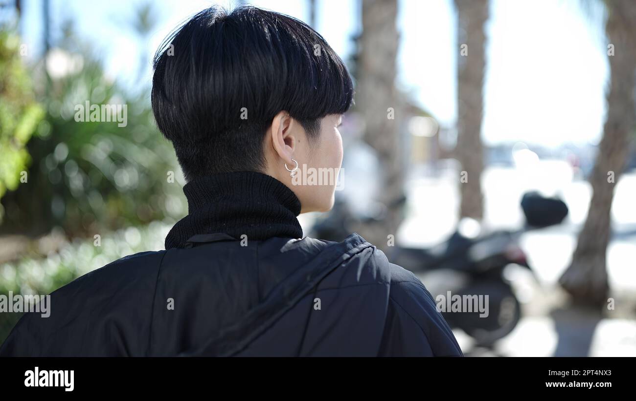 Young chinese woman standing on back view at park Stock Photo - Alamy