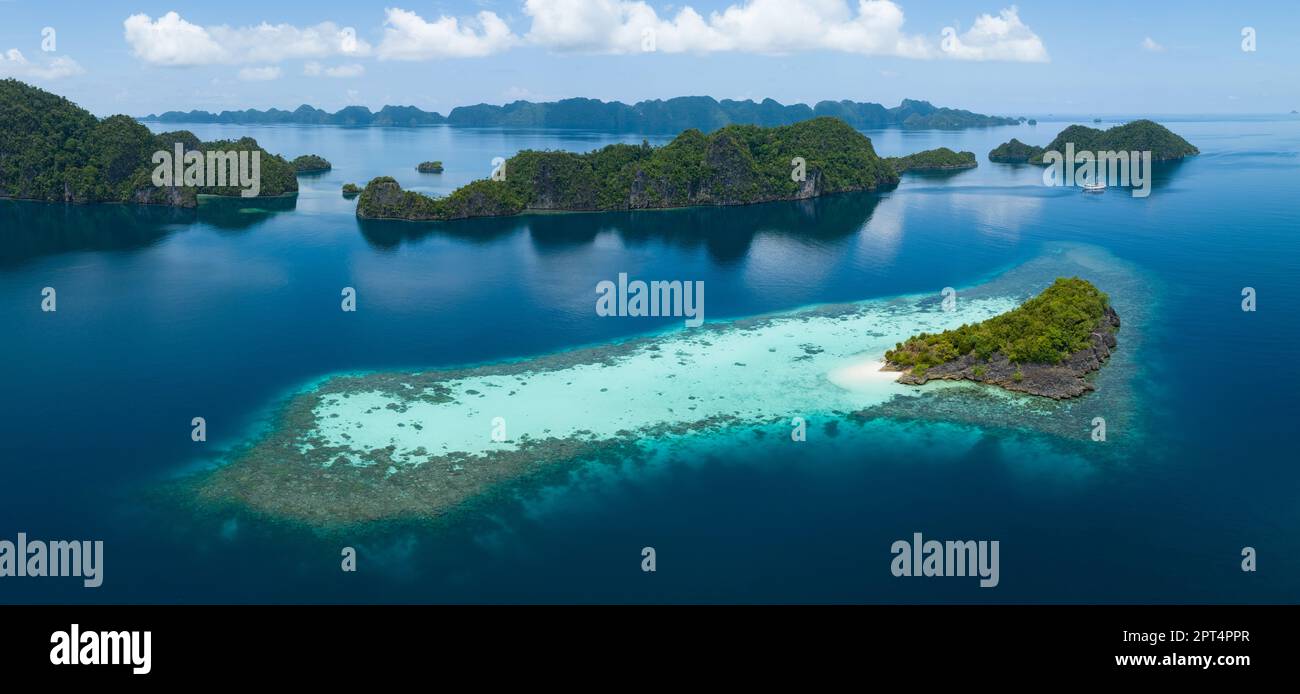 Beautiful coral reefs surround the dramatic limestone islands that rise ...
