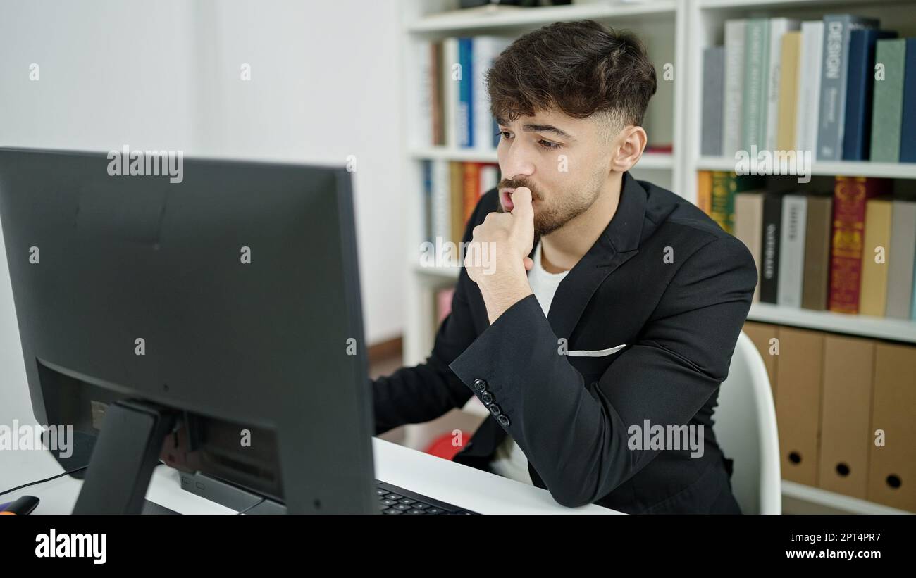 Young arab man student using computer studying at university classroom ...