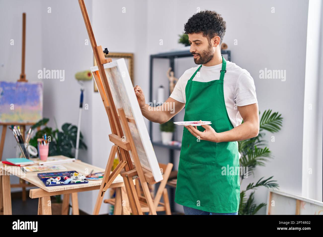 Young arab man artist smiling confident drawing at art studio Stock ...