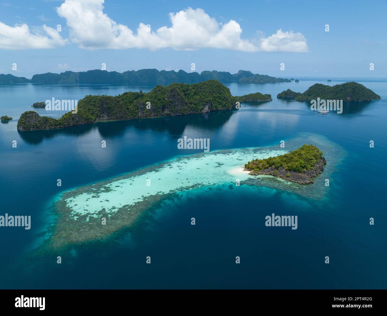 Beautiful coral reefs surround the dramatic limestone islands that rise ...