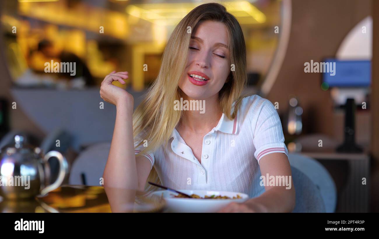 Blonde woman speaking at restaurant hi-res stock photography and images ...