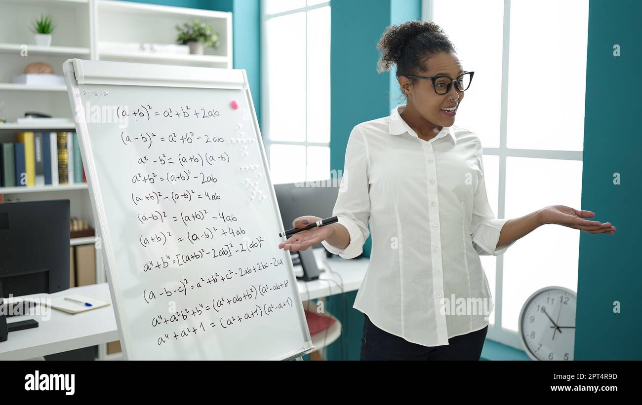 African american woman teacher explaining maths lesson at classroom ...