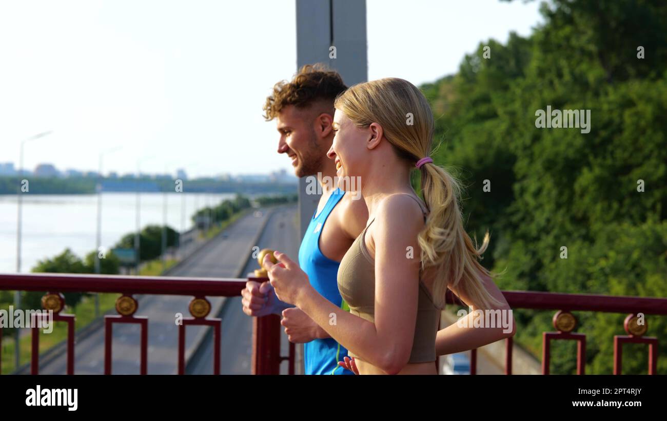 Close up of cheerful Caucasian man and woman running working out ...