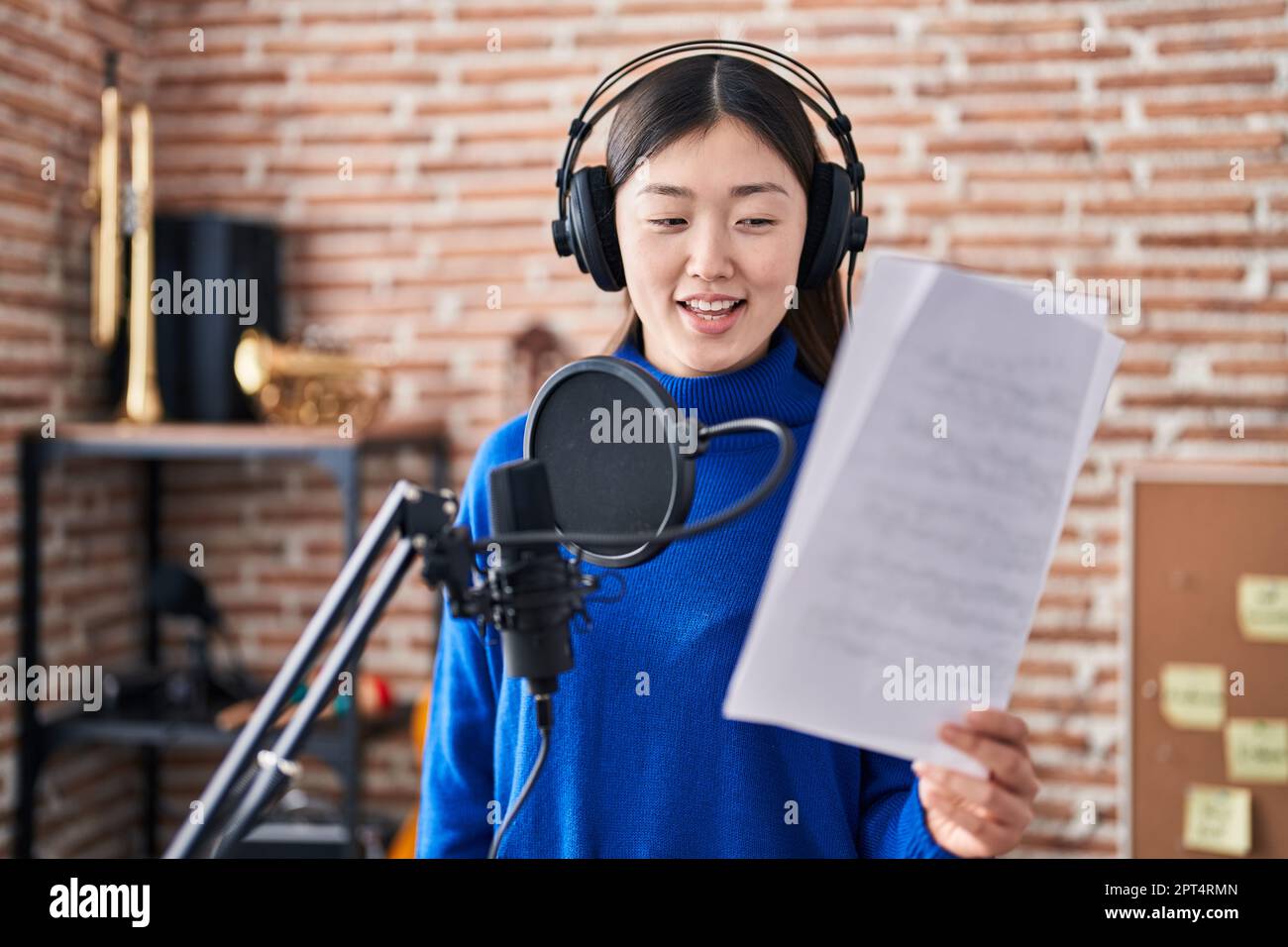 Chinese woman artist singing song at music studio Stock Photo - Alamy