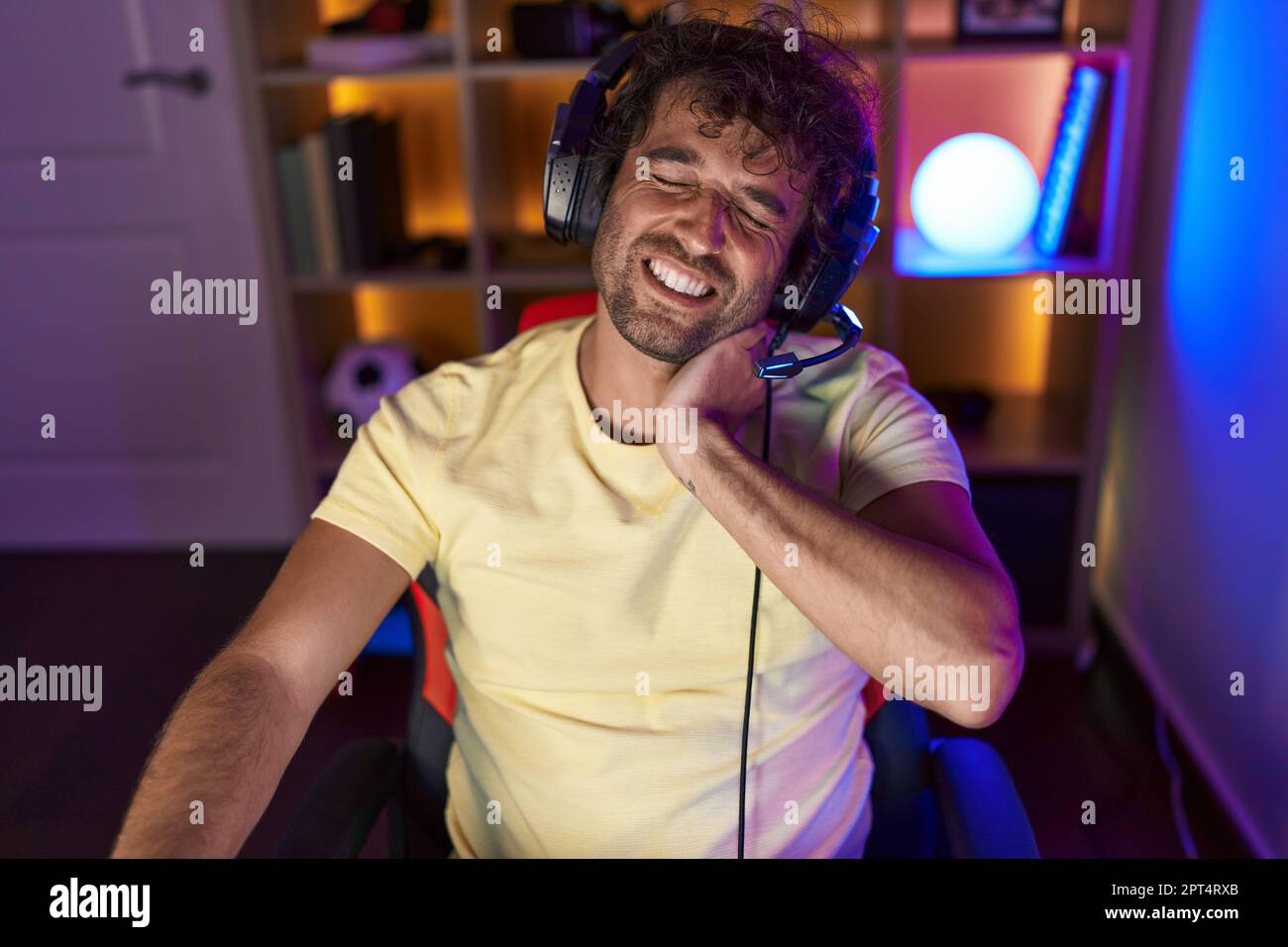 Young hispanic man streamer using computer suffering for neck pain at ...