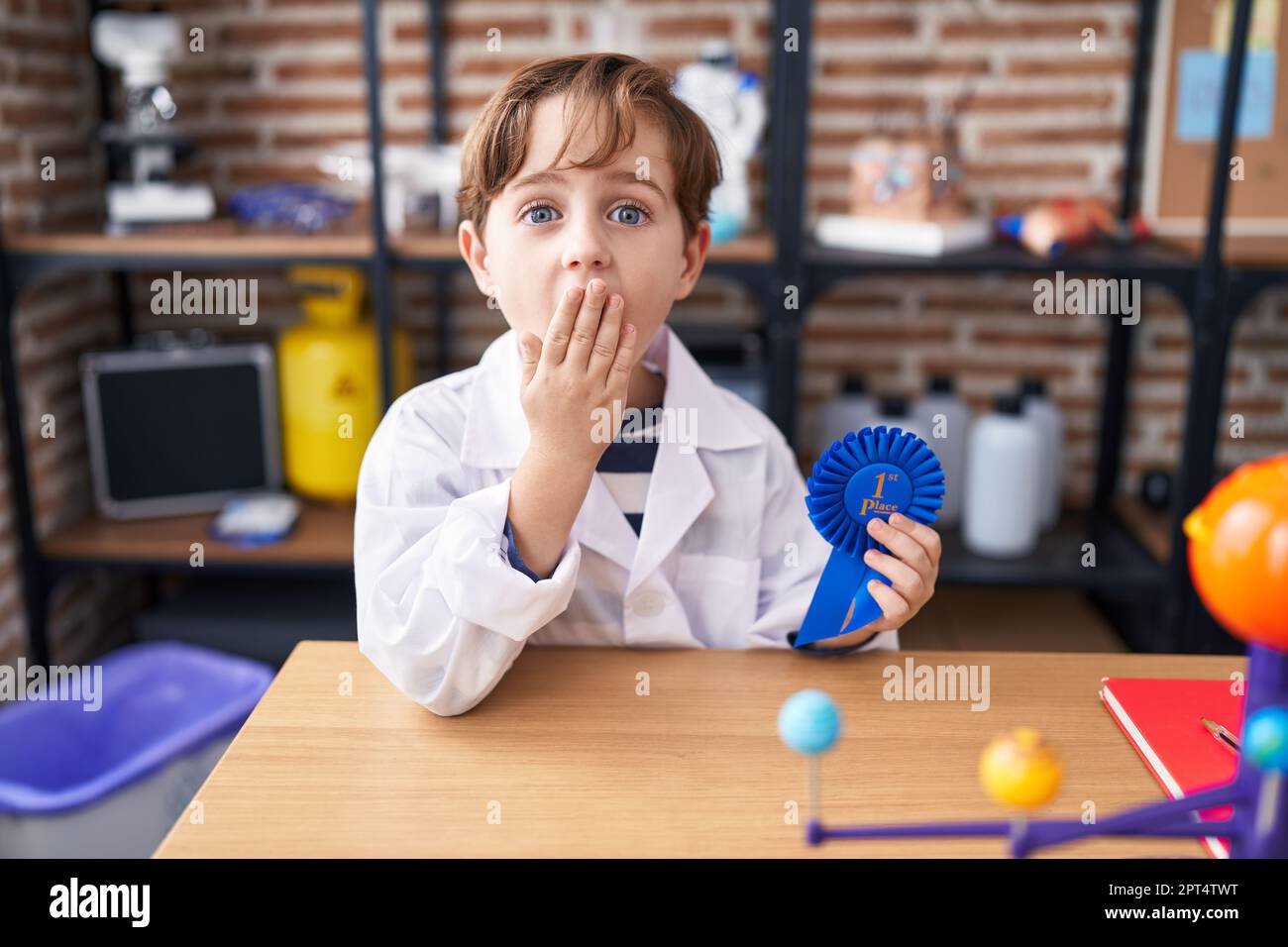 Little caucasian boy at school scientist laboratory winning first prize ...