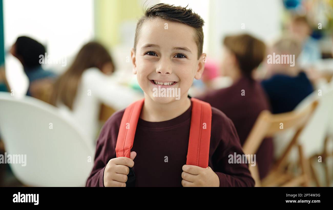 Adorable hispanic boy student smiling confident standing at classroom ...
