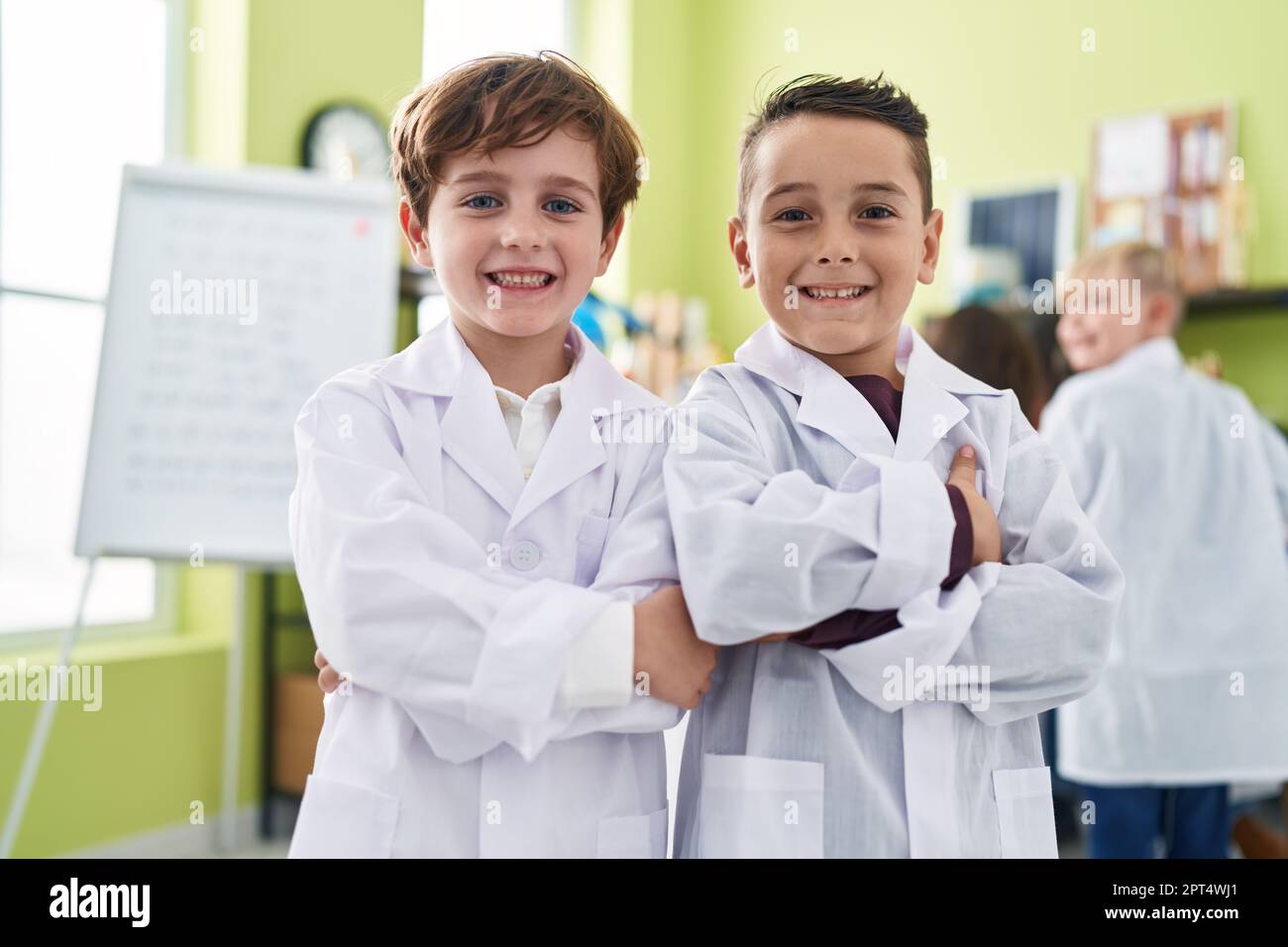 Adorable boys student smiling confident standing with arms crossed ...