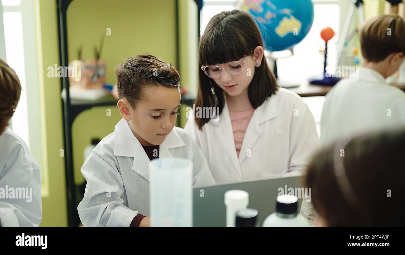 Group of kids scientists students using laptop at laboratory classroom ...