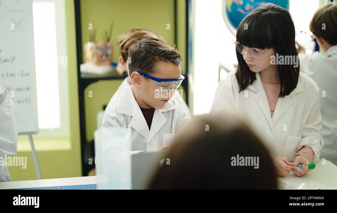 Group of kids scientists students using laptop holding molecules at ...