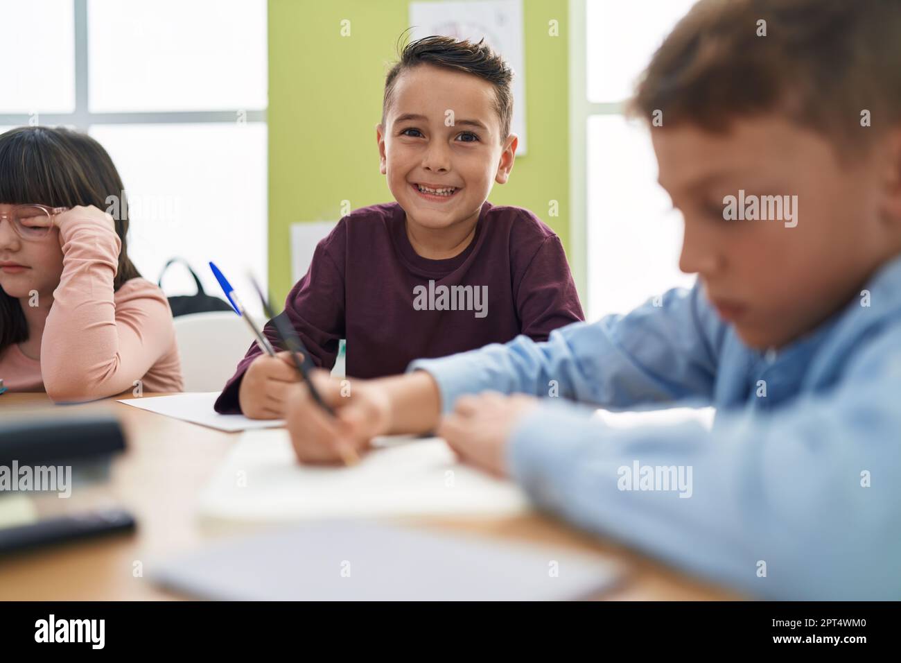 Group of kids students sitting on table studying at classroom Stock ...