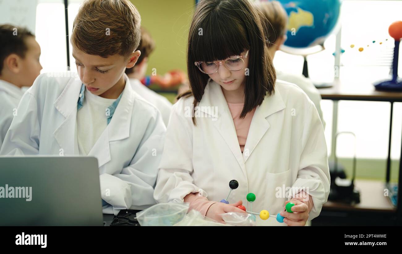 Group of kids scientists students using laptop holding molecules at ...