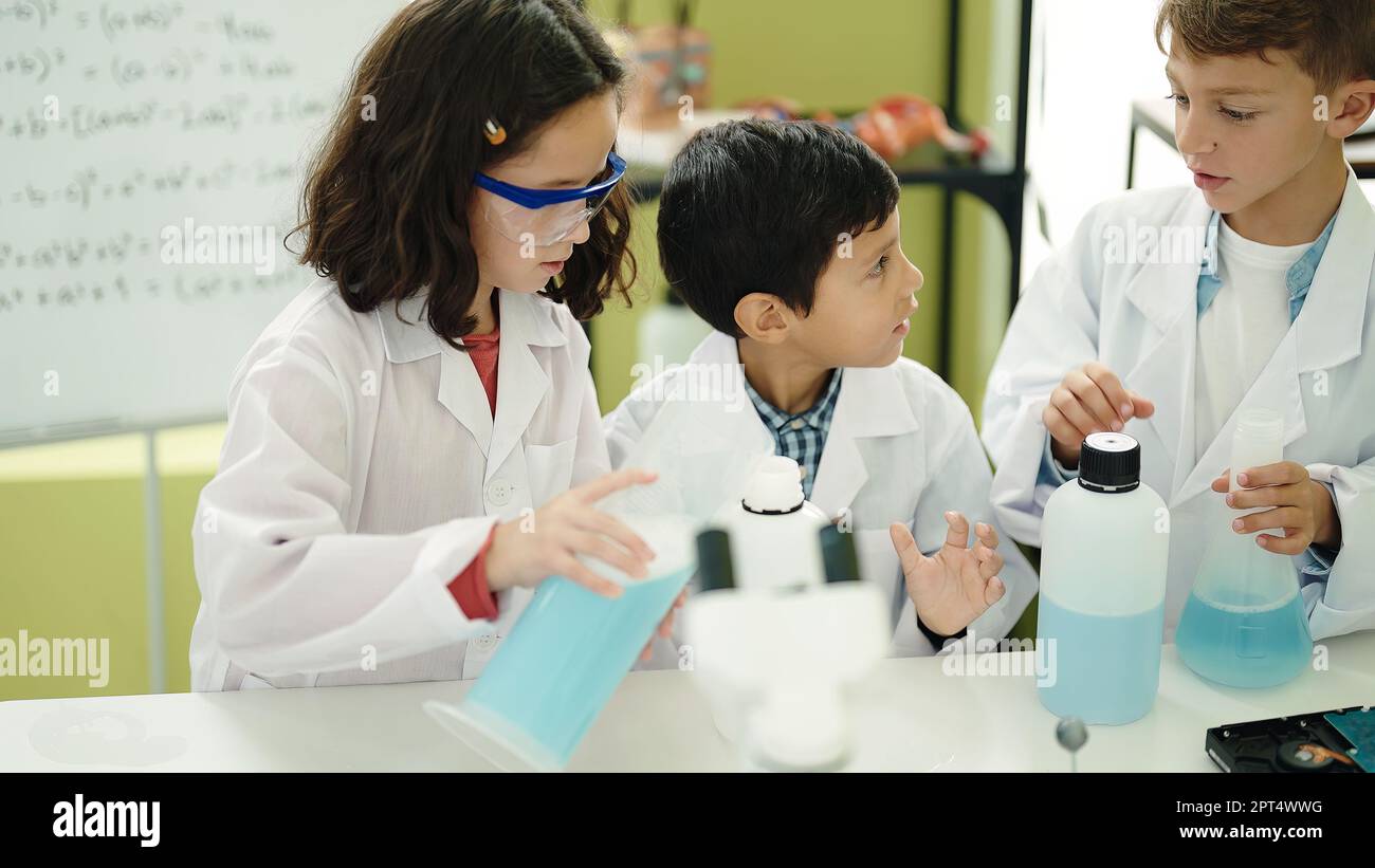 Group of kids students pouring liquid on bottl doing experiment at ...