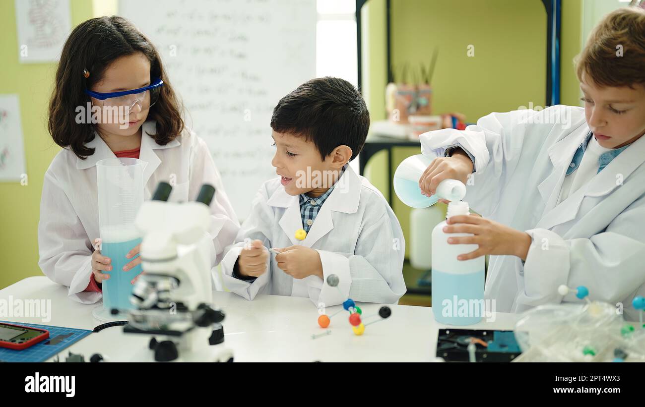 Group of kids students pouring liquid on bottl doing experiment at ...