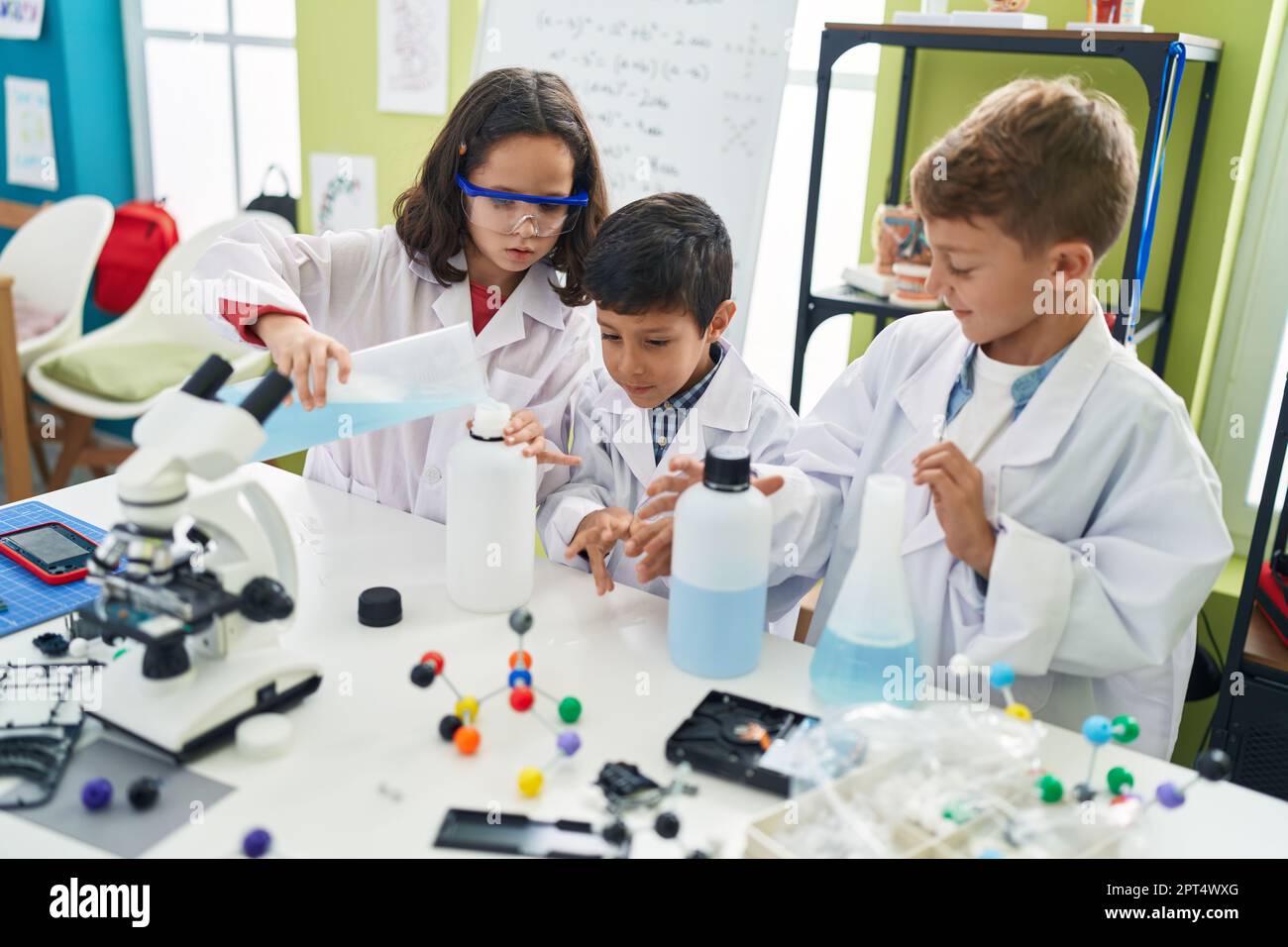 Group of kids students pouring liquid on bottl doing experiment at ...