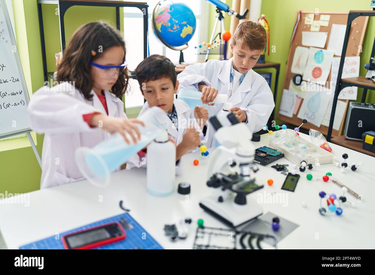 Group of kids students pouring liquid on bottl doing experiment at ...