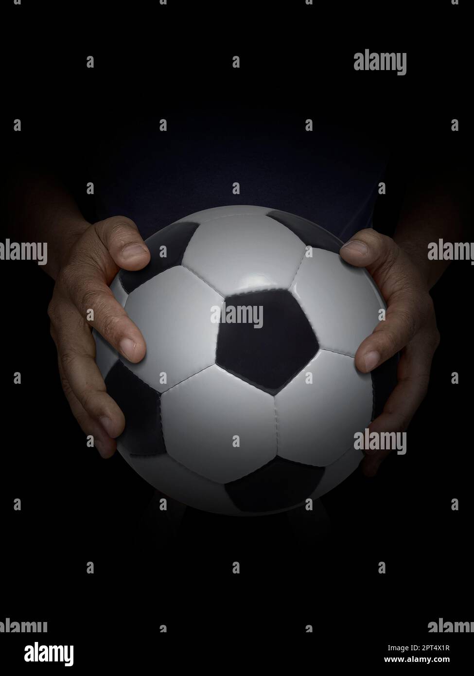 Soccer ball in male hand on black background Stock Photo - Alamy