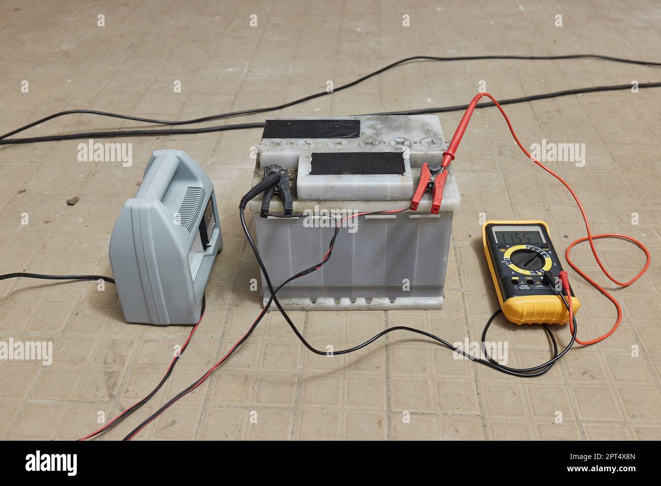 Charging a car starter battery, in a garage, monitoring state with ...