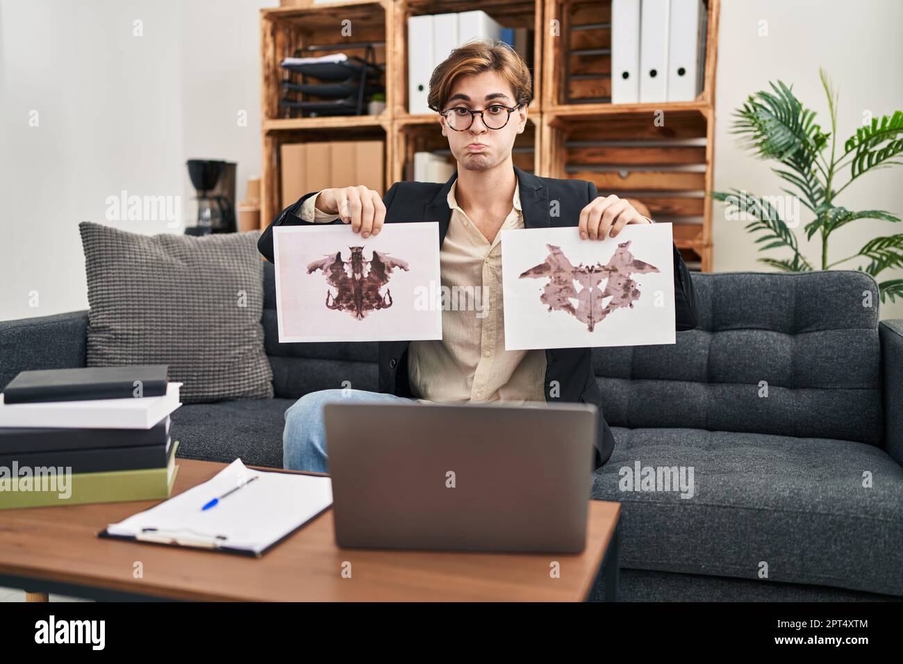 Young therapist man working with rorschach test at psychology clinic ...