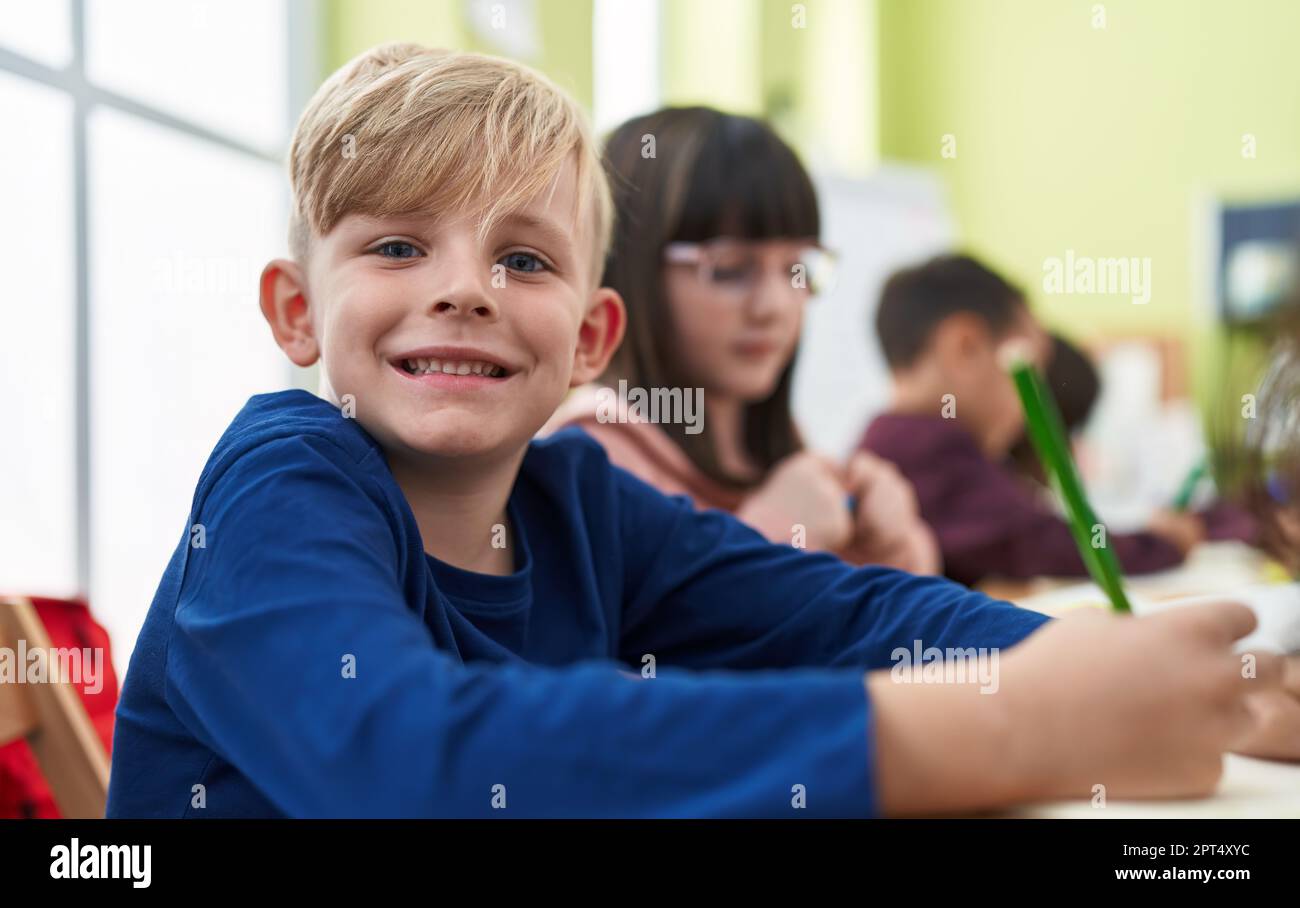 Adorable boy and girl students smiling confident drawing on notebook at ...