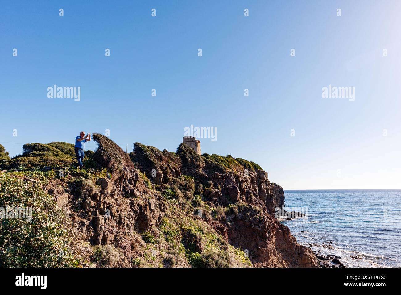 Man taking a photo just before falling off a cliff Stock Photo - Alamy