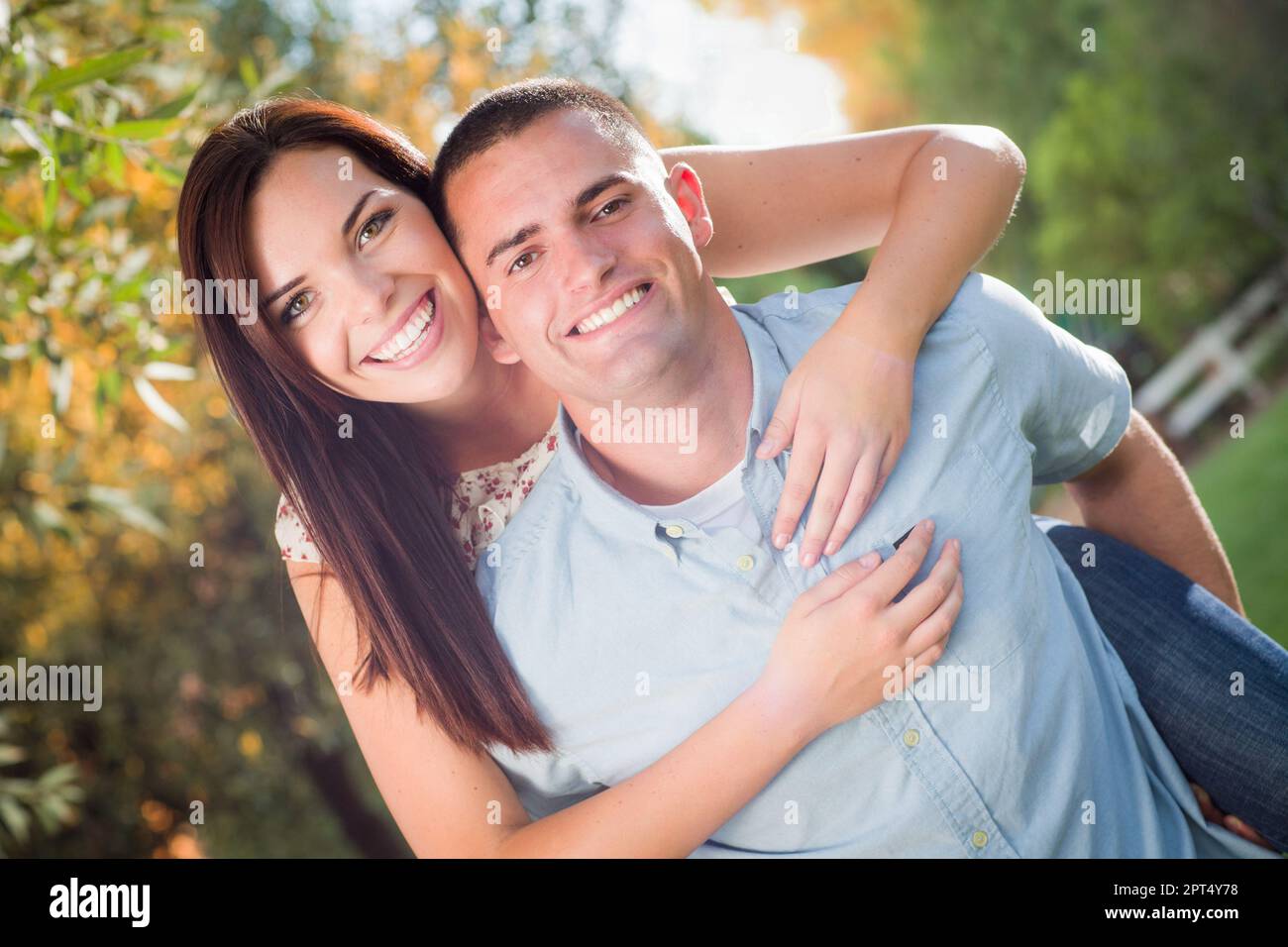 Happy Romantic Caucasian Couple Piggyback Riding in the Park Stock ...