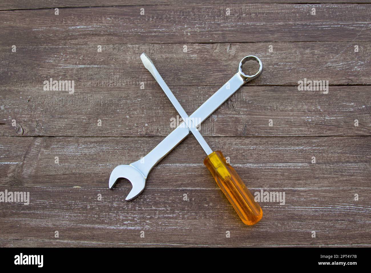 Image of a wrench and a screwdriver placed crosswise. Handyman's tools ...