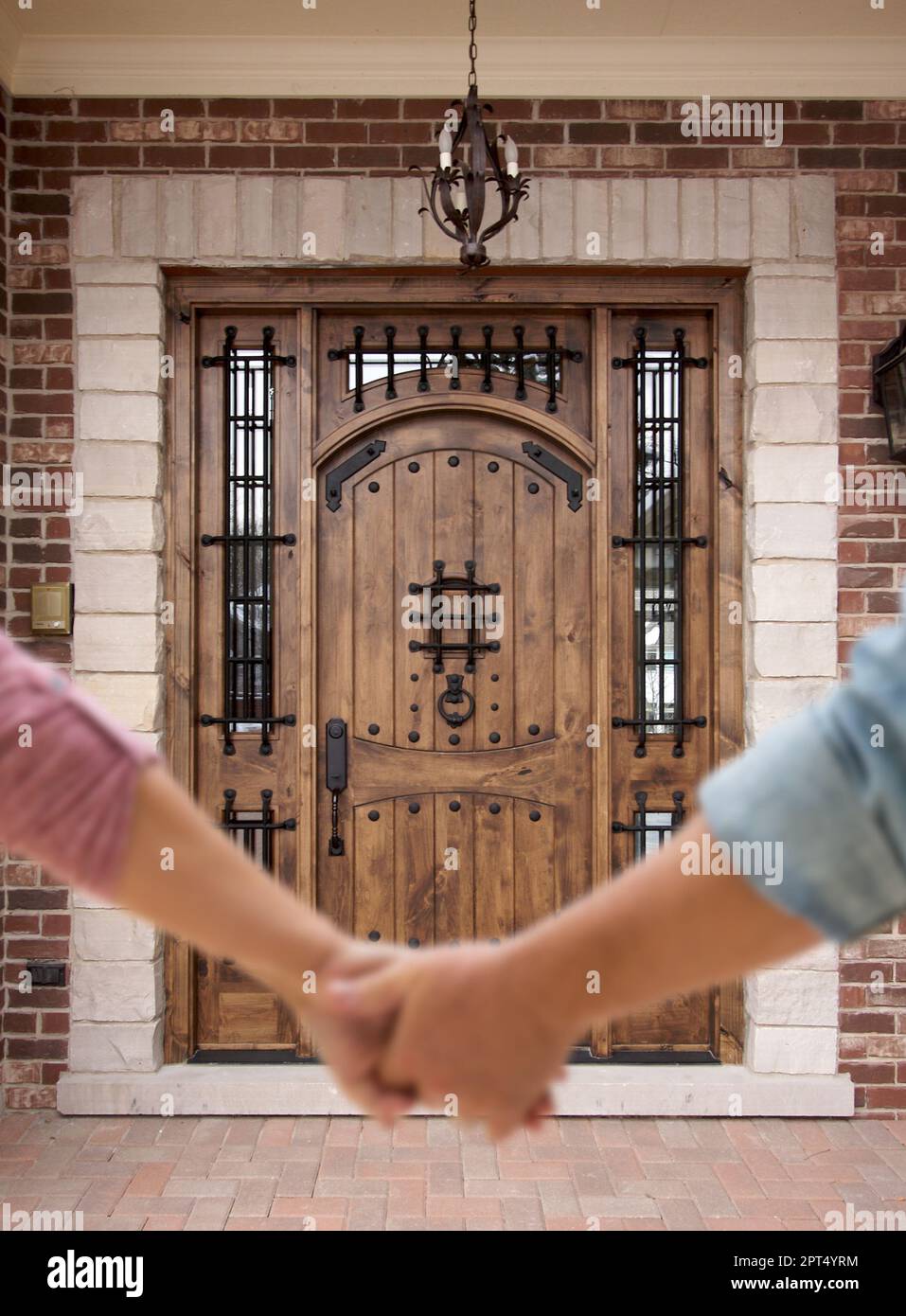 Couple Holding Hands Approaching Front Door of House Stock Photo - Alamy