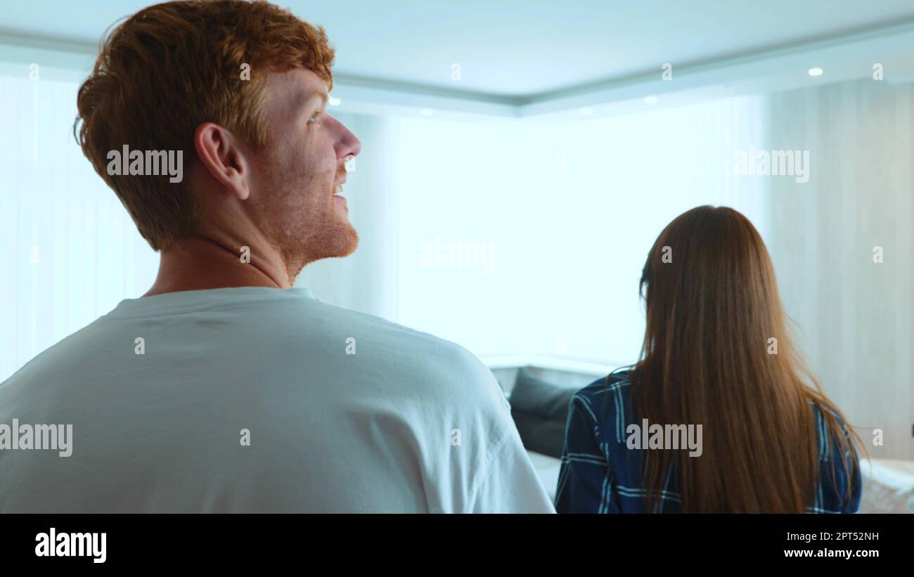 Caucasian young married couple entering the apartment and hugging ...