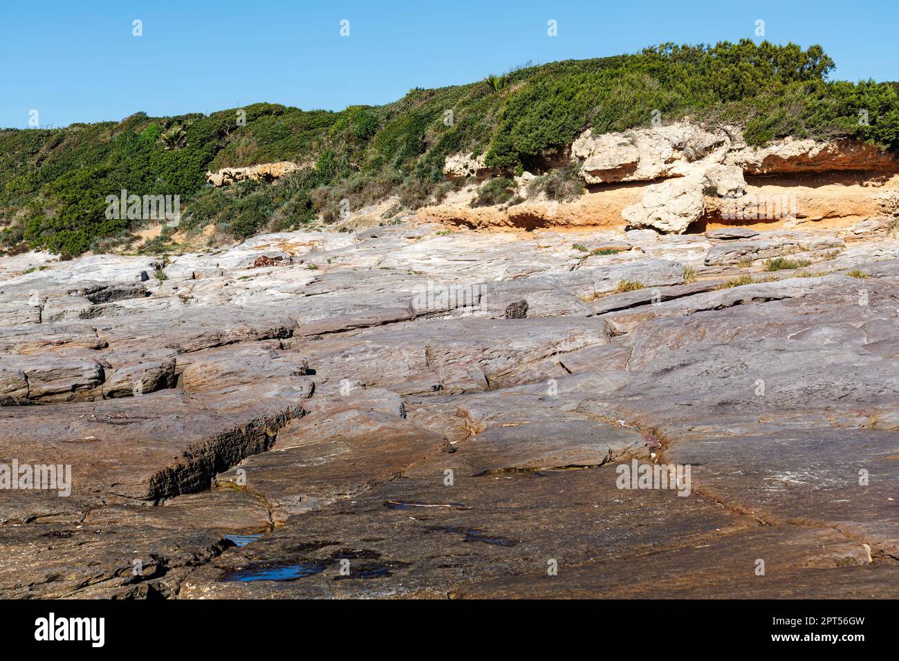 unusual rock formations of the volcanic cliff on Cala Sapone beach ...