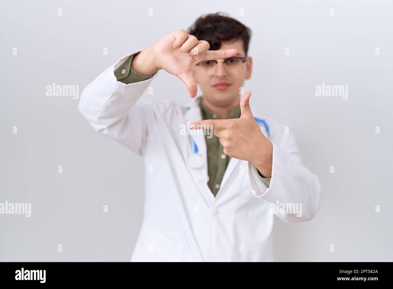 Young non binary man wearing doctor uniform and stethoscope smiling ...