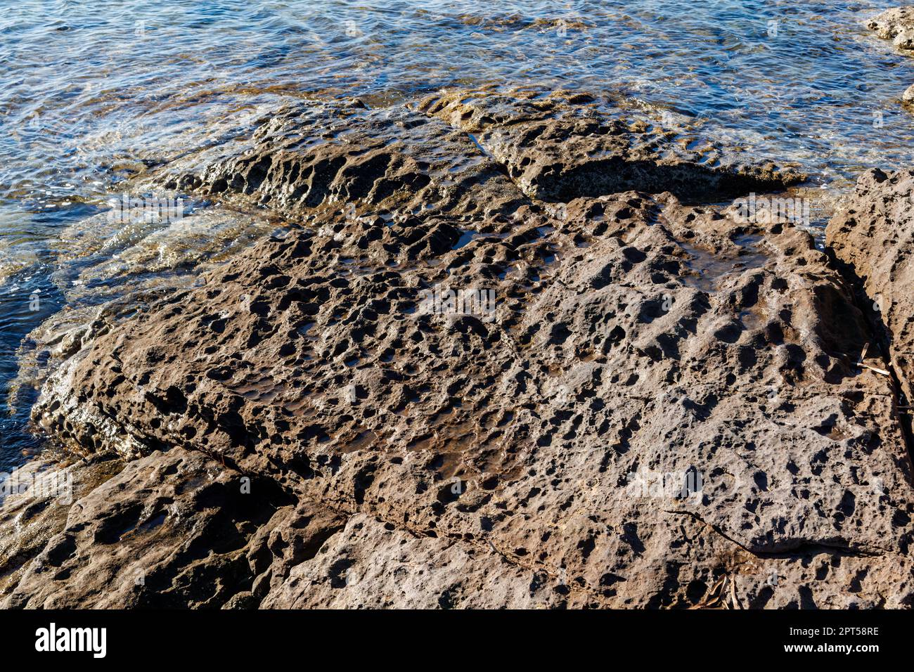 unusual rock formations of the volcanic cliff on Cala Sapone beach ...