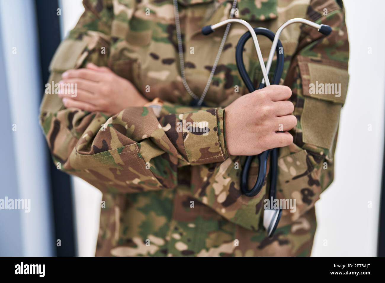 Young hispanic woman army doctor holding stethoscope at home Stock ...