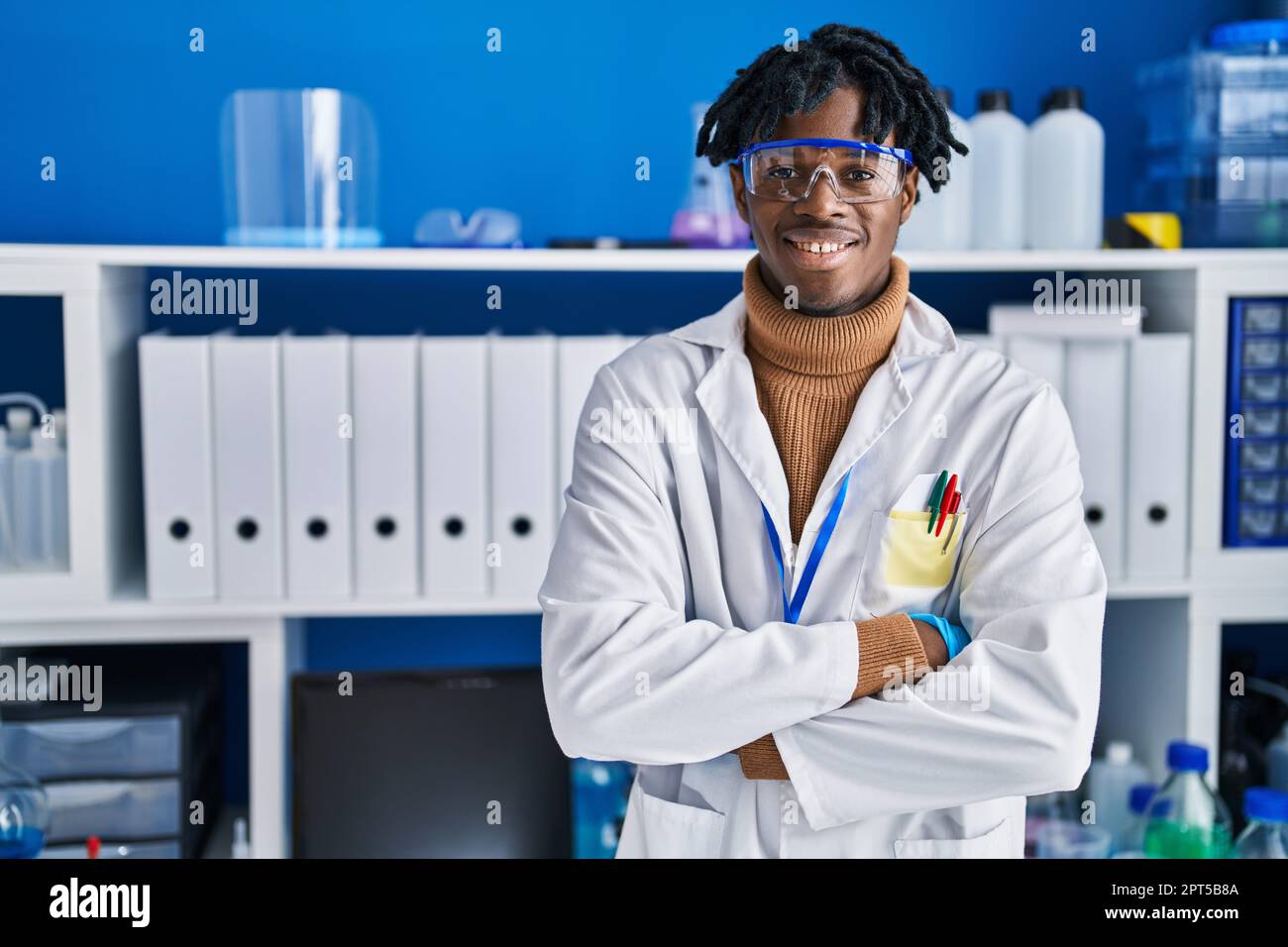 African american man scientist standing with arms crossed gesture at ...