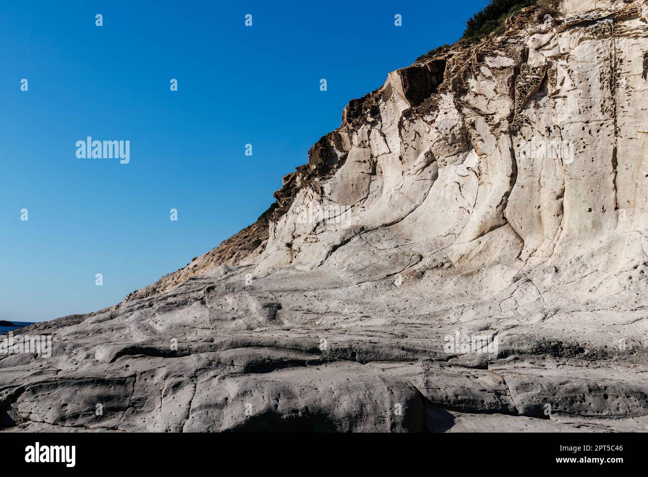 unusual rock formations of the volcanic cliff on Cala Sapone beach ...