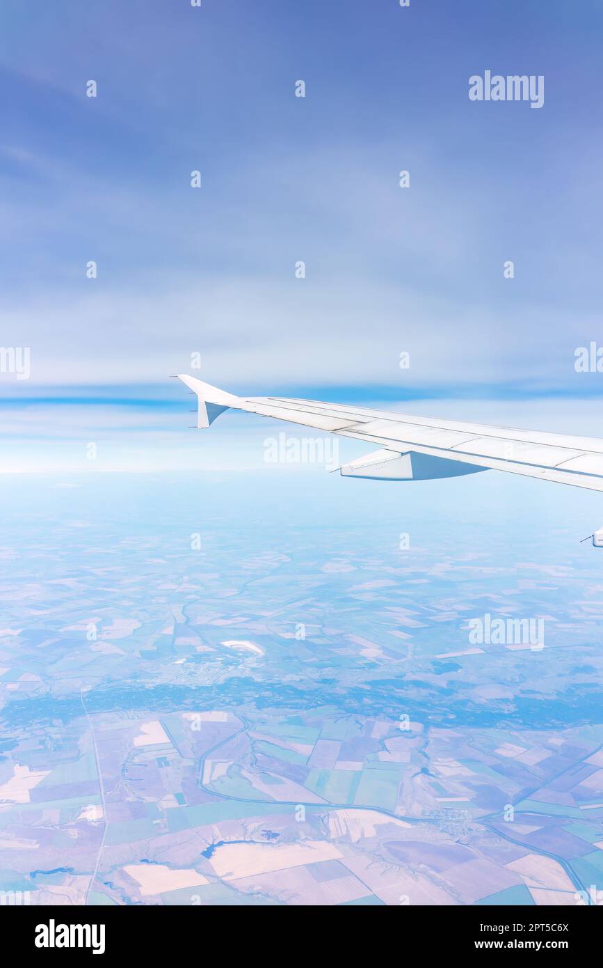 Aerial view from airplane window above green ground. View from the ...