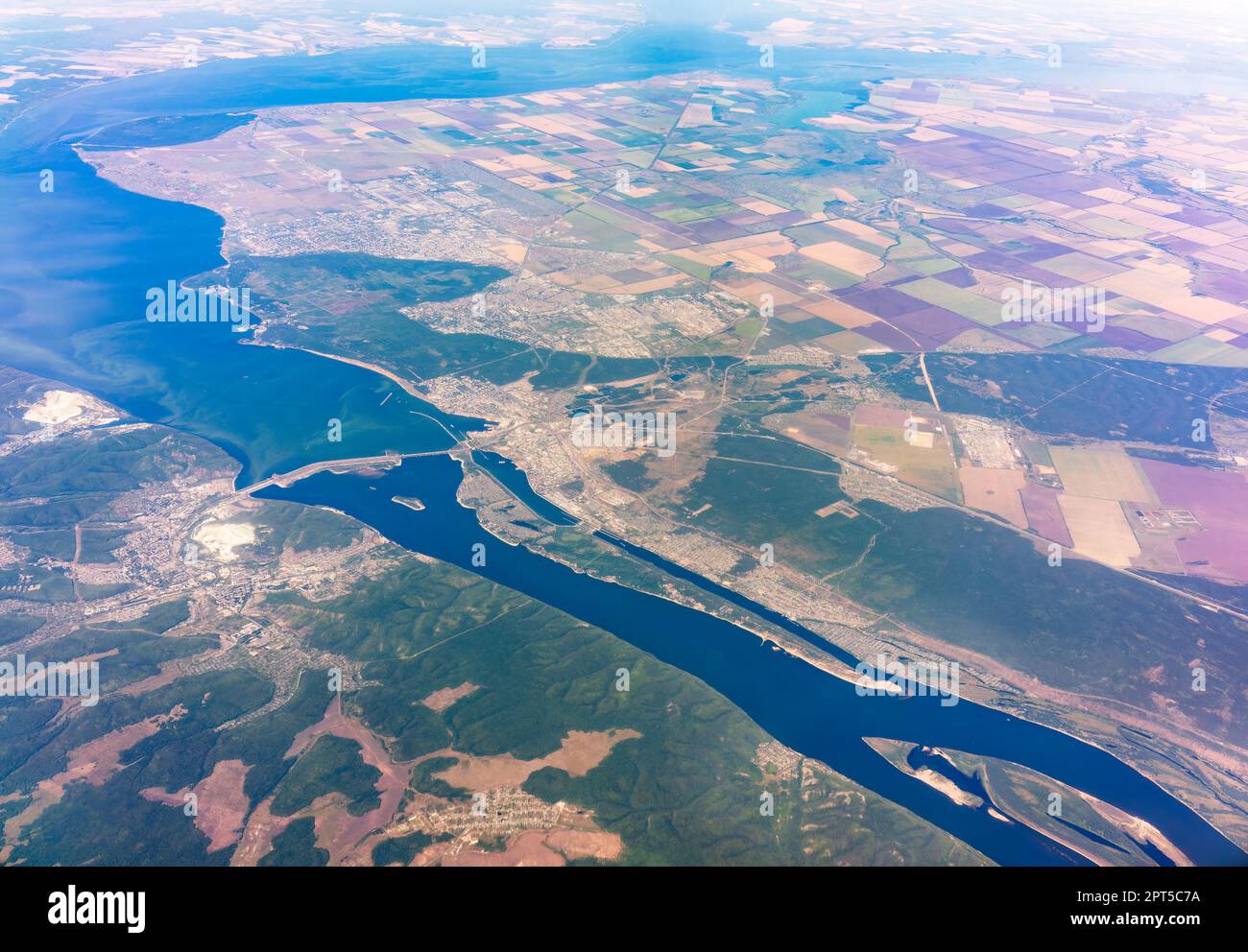 Aerial view from airplane window above green ground. View from the ...