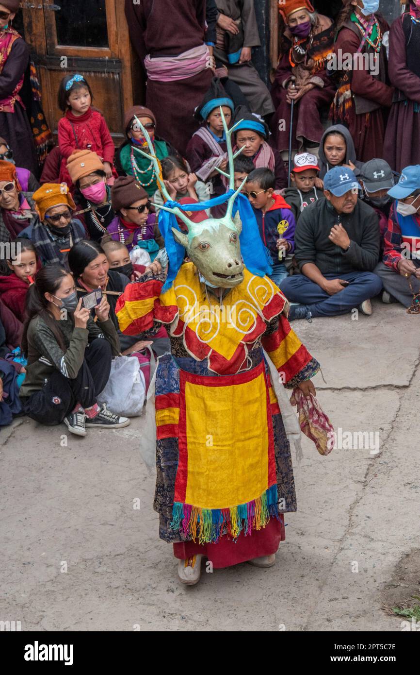 A masked Monk dances in front of the crowd at the Stongdey Monastery ...