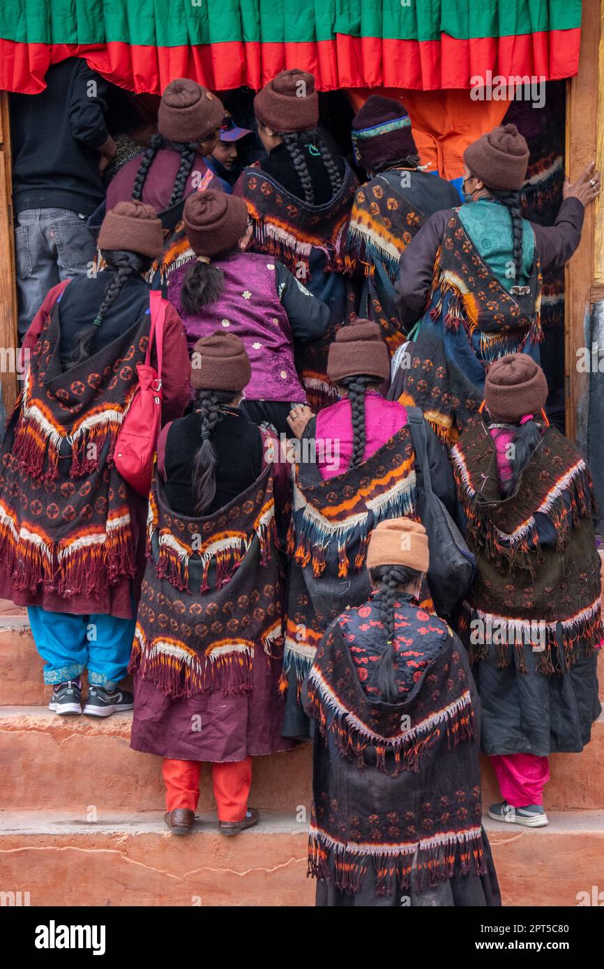 Traditionally dressed women enter the prayer hall during Stongdey ...