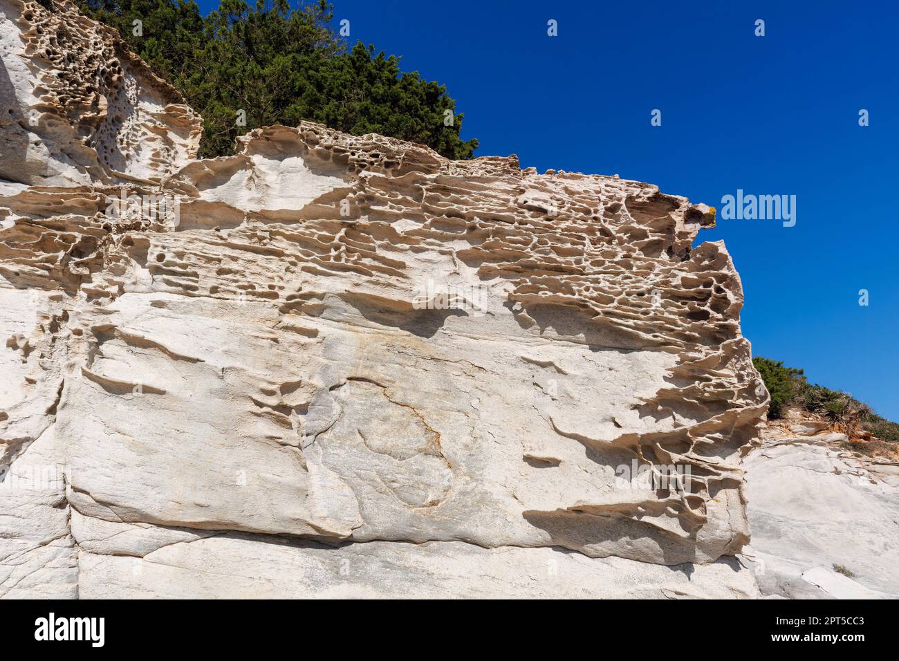 unusual rock formations of the volcanic cliff on Cala Sapone beach ...