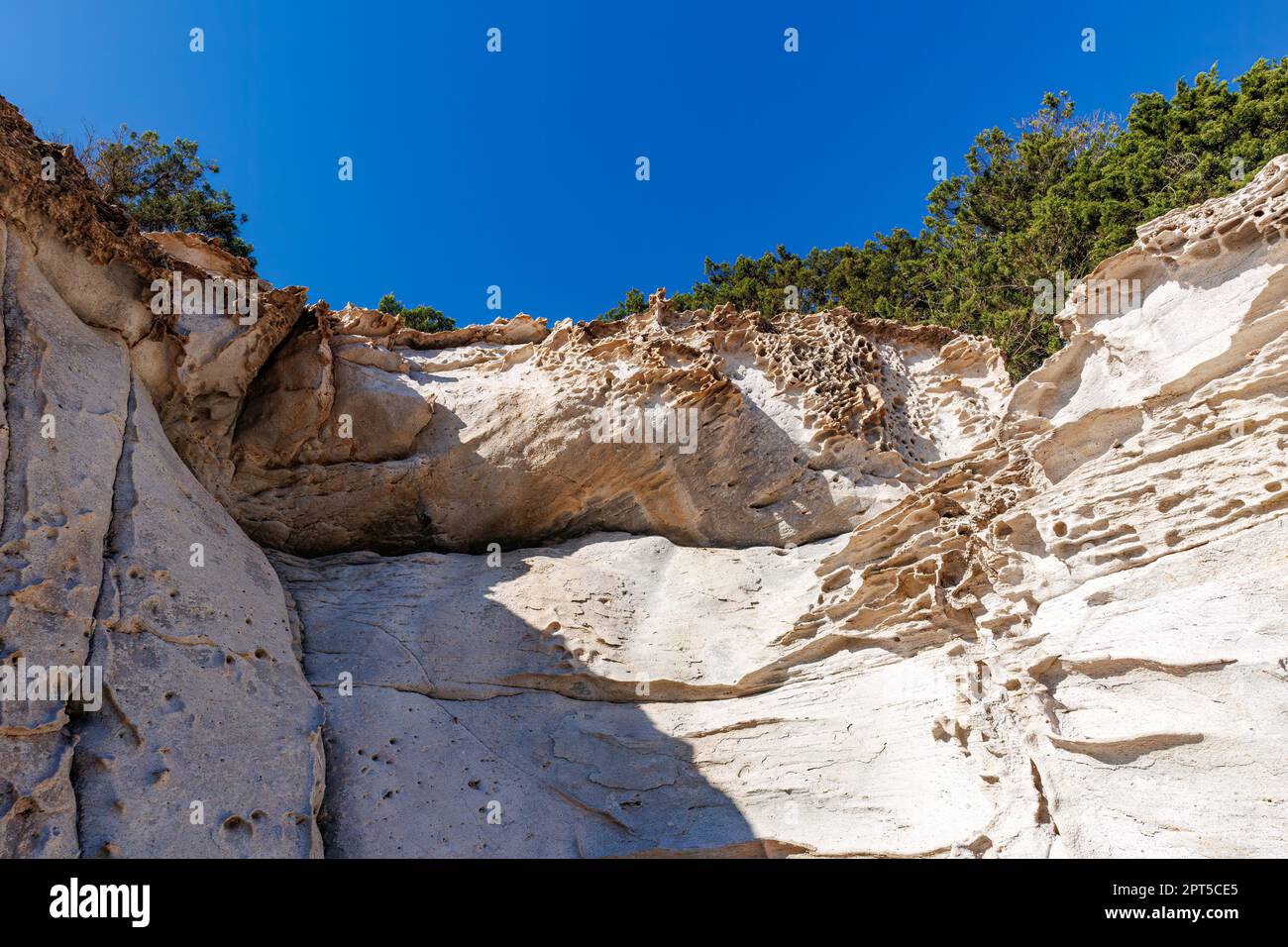 unusual rock formations of the volcanic cliff on Cala Sapone beach ...