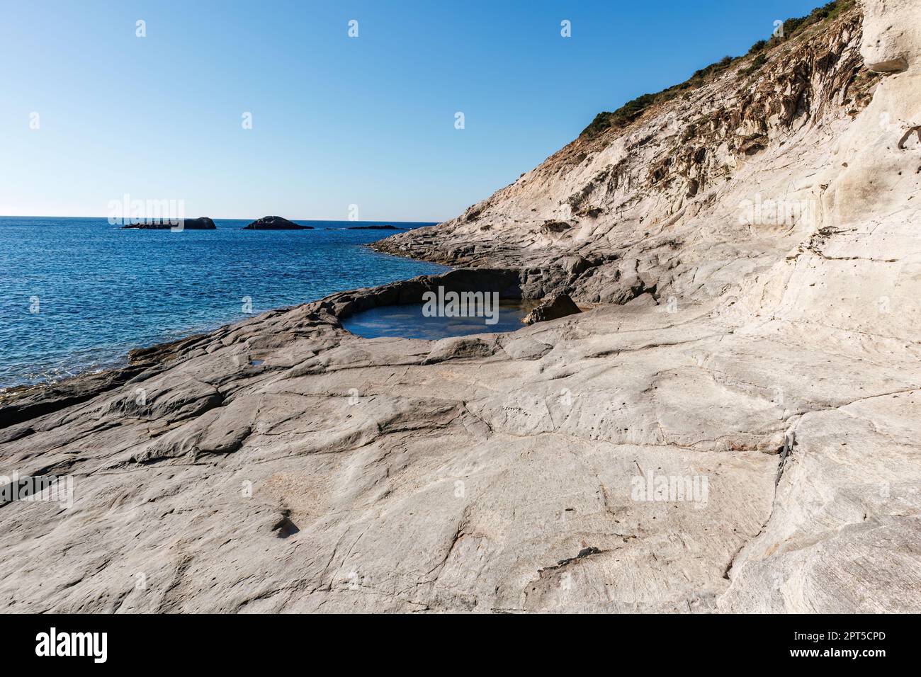 unusual rock formations of the volcanic cliff on Cala Sapone beach ...