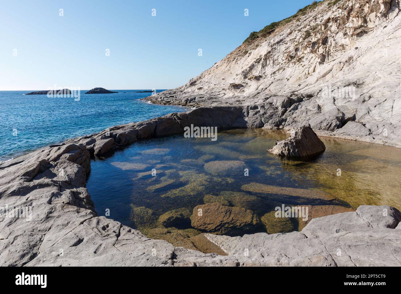 unusual rock formations of the volcanic cliff on Cala Sapone beach ...