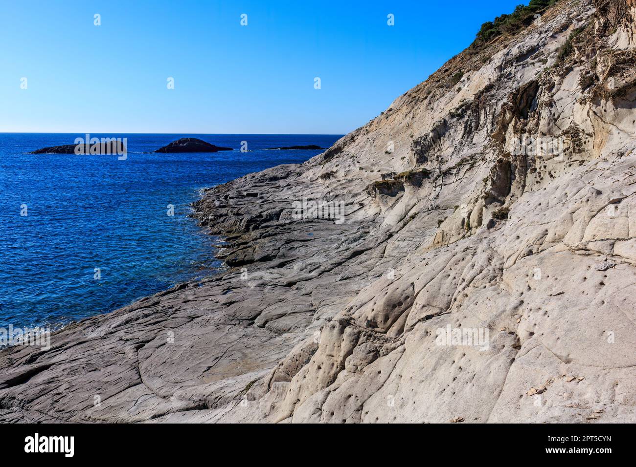 unusual rock formations of the volcanic cliff on Cala Sapone beach ...