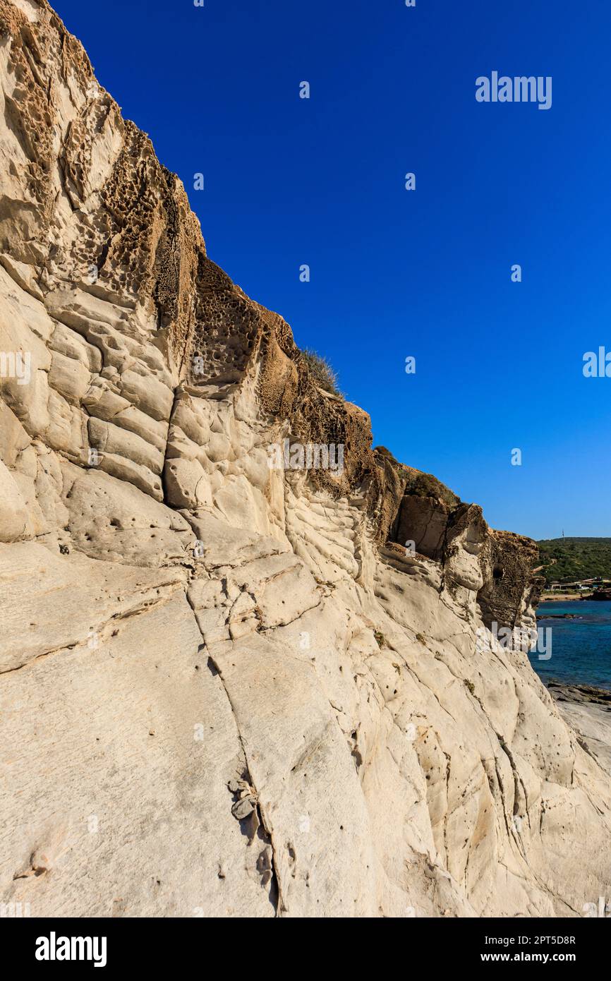 unusual rock formations of the volcanic cliff on Cala Sapone beach ...