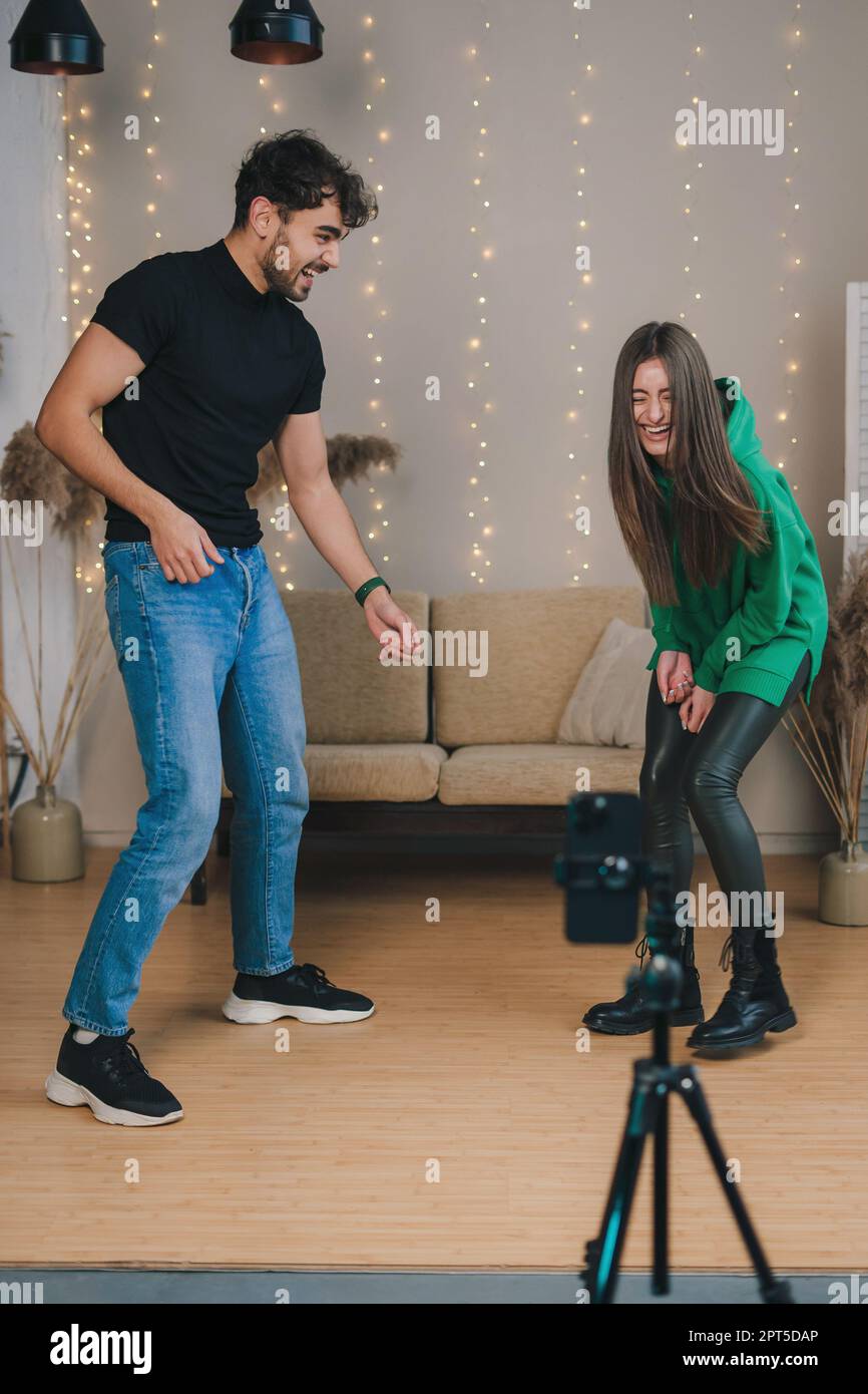 Two people influencer man and woman, recording dancing video with ...
